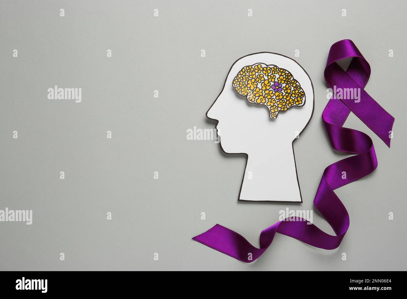 Human head cutout, brain and purple ribbon on light grey background ...