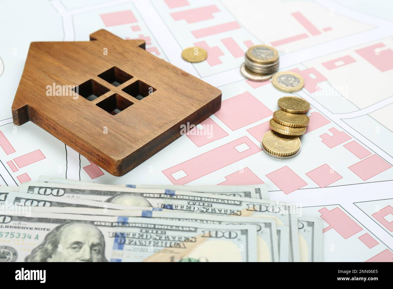 Money and wooden house model on cadastral map Stock Photo - Alamy