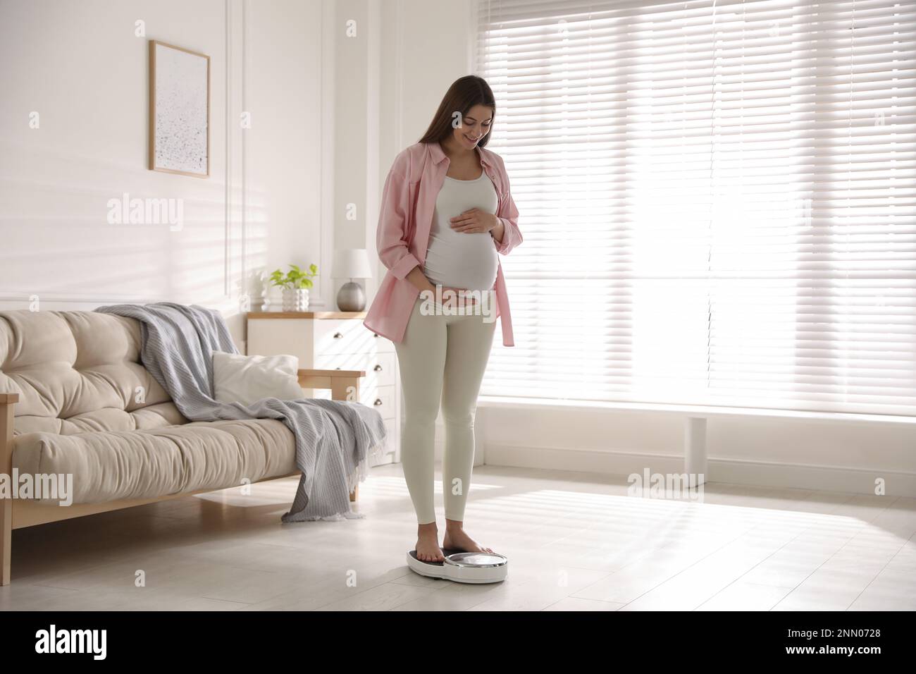 Woman standing on scales hi-res stock photography and images - Alamy