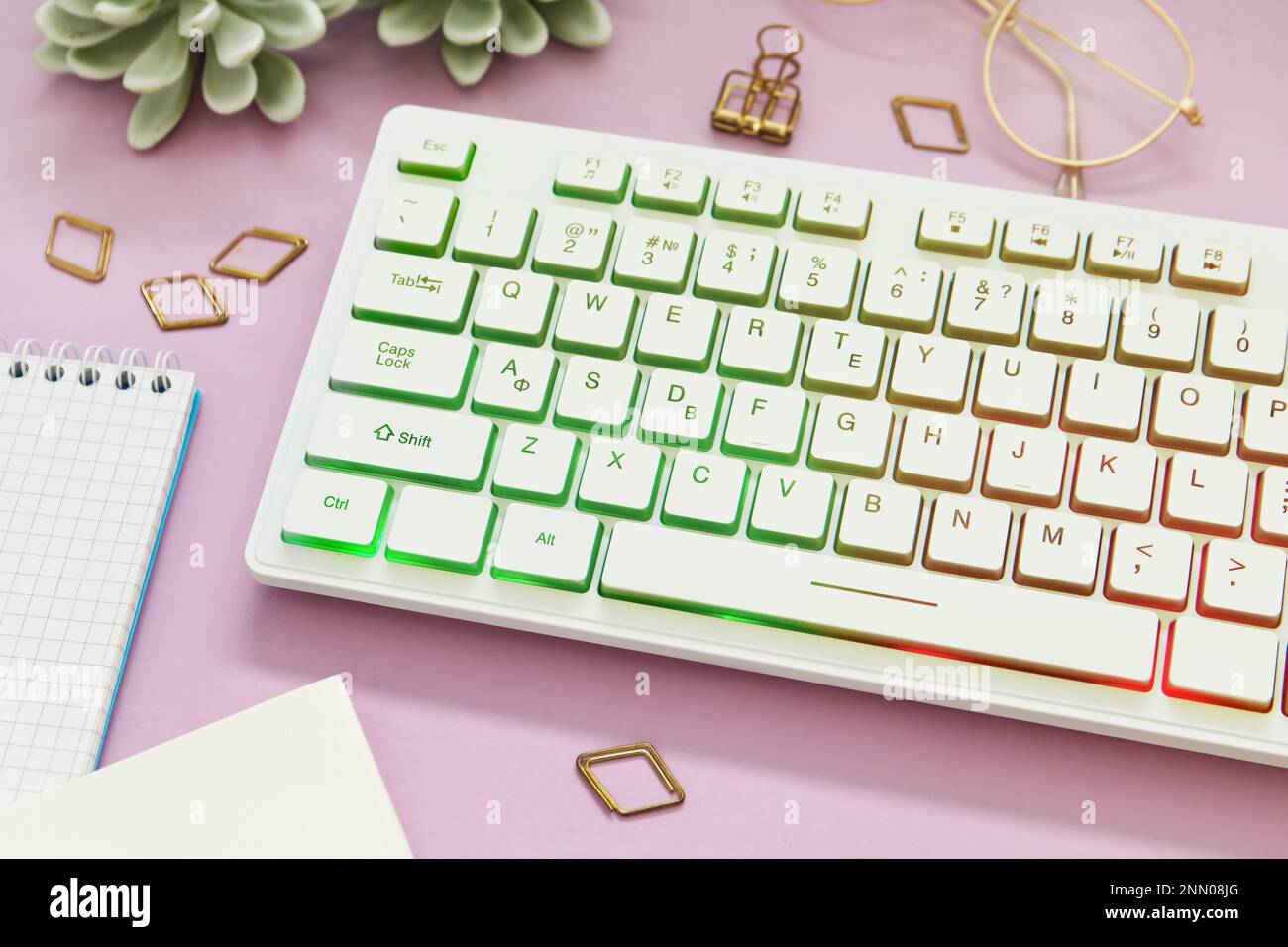 Modern RGB keyboard on pink background, above view Stock Photo - Alamy