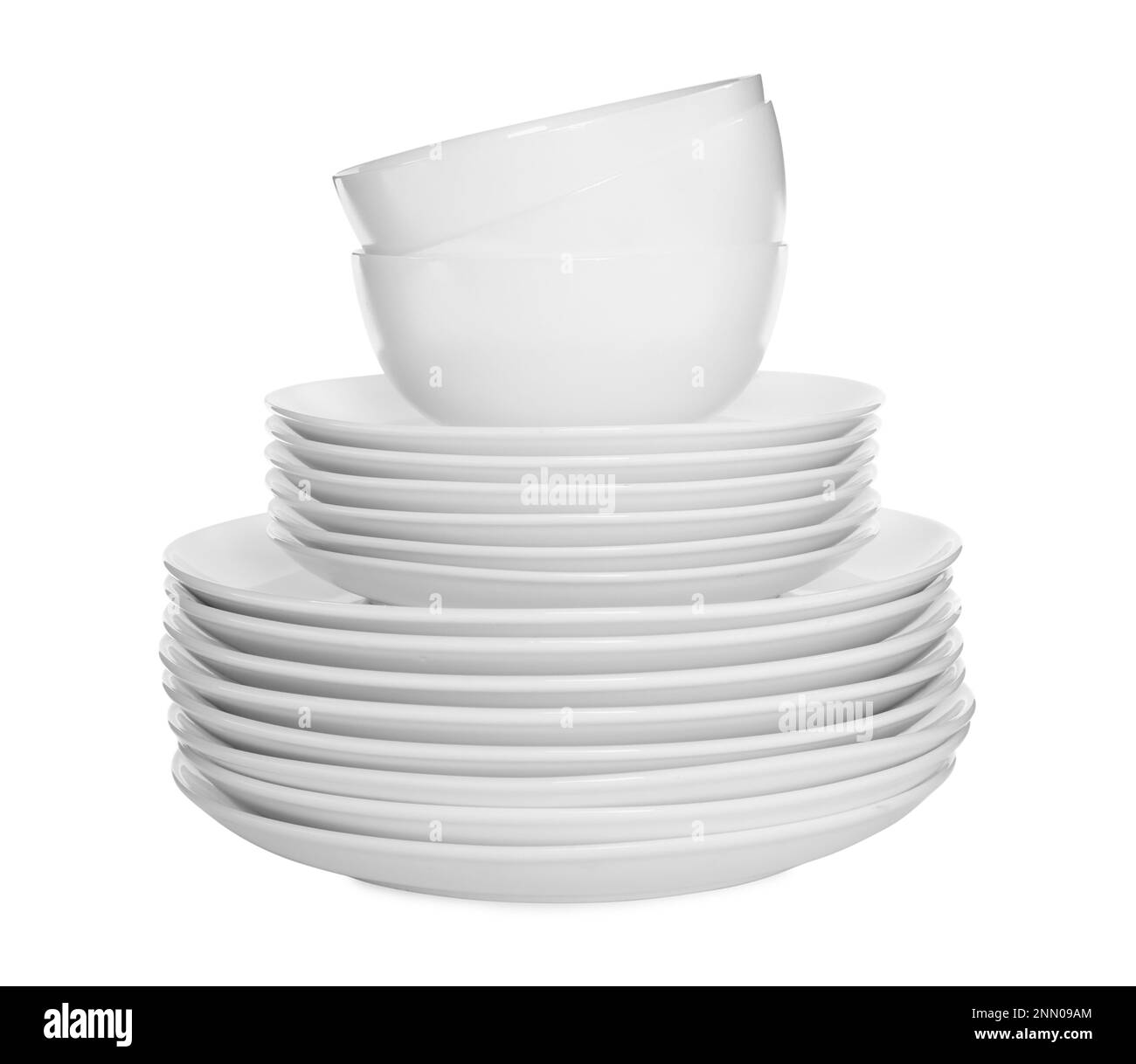 Stacked plates and cups on white background Stock Photo - Alamy