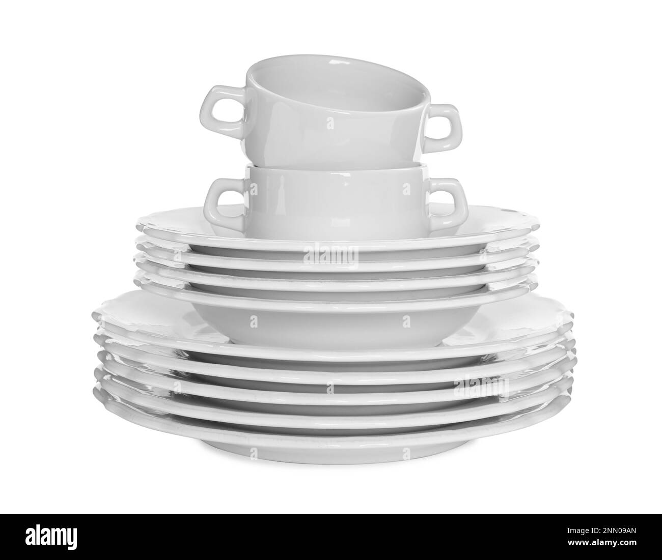 Stacked plates and cups on white background Stock Photo - Alamy