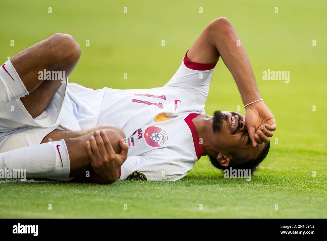 AUSTIN, TX - JULY 29: Qatar forward Akram Afif (11) holds his knee ...