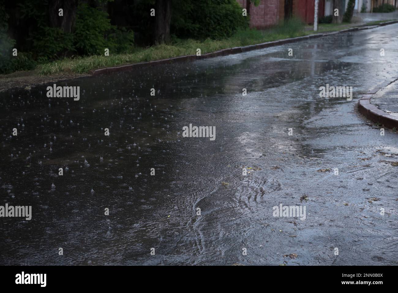 View of heavy pouring rain on city street Stock Photo - Alamy