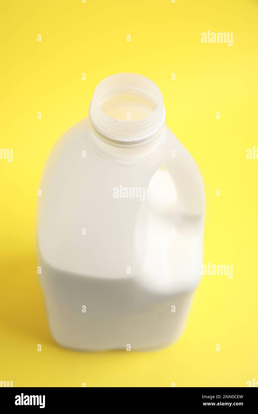 Gallon bottle of milk on yellow background Stock Photo - Alamy