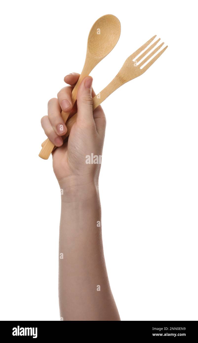 Woman holding eco friendly cutlery on white background, closeup ...
