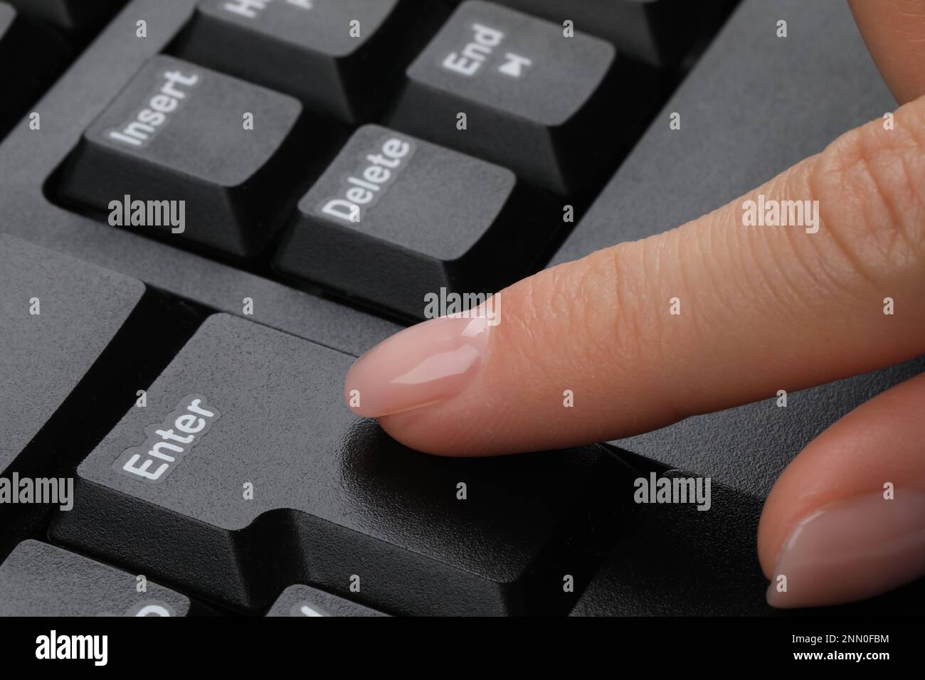 Woman pressing button on computer keyboard, closeup Stock Photo - Alamy