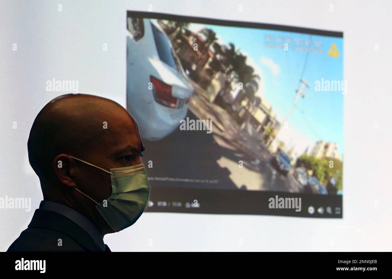 Defense Attorney Thomas Otake stands in front of a video projection of ...