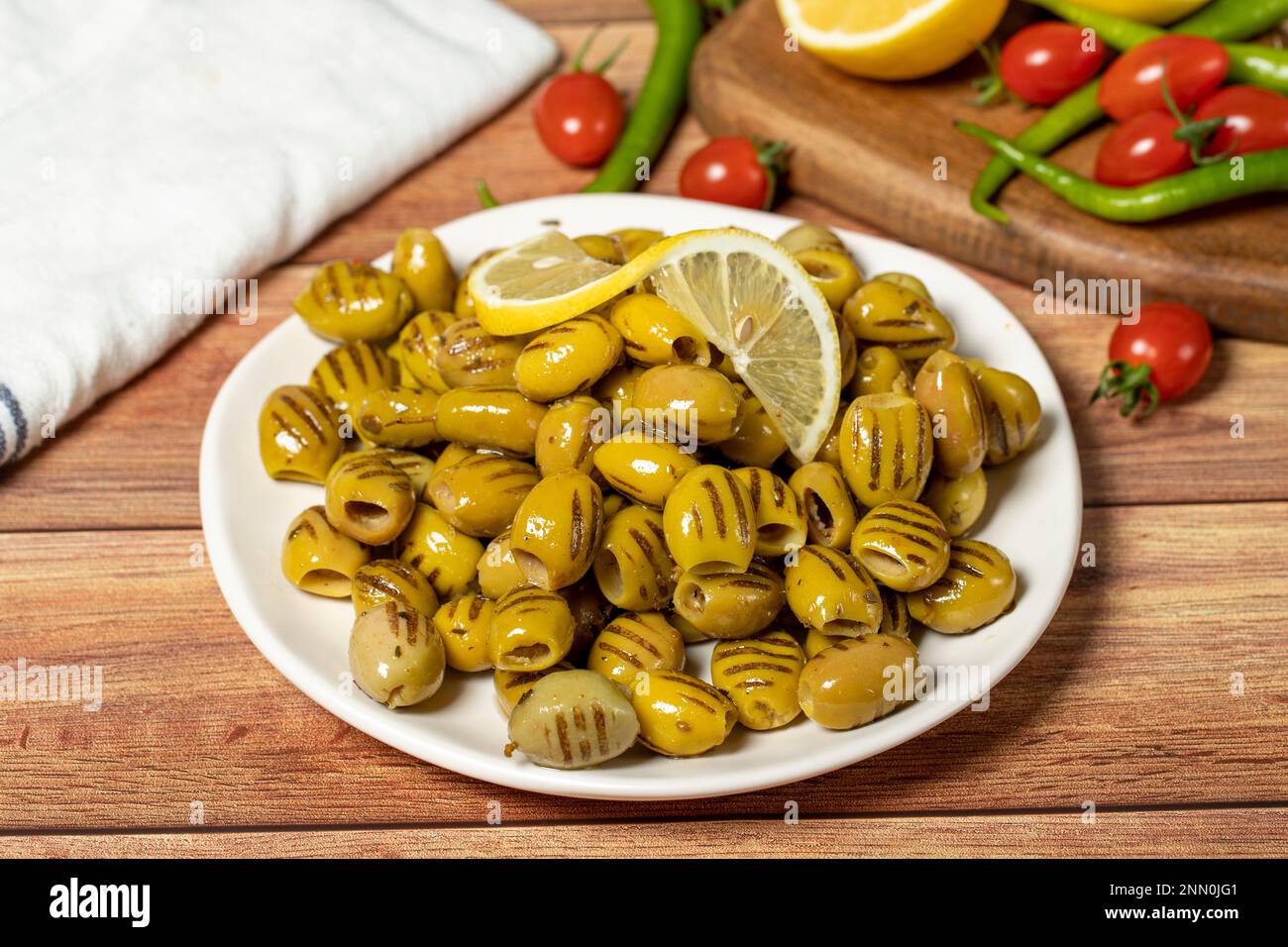 Grilled olives. Special green olives on a wood background ...