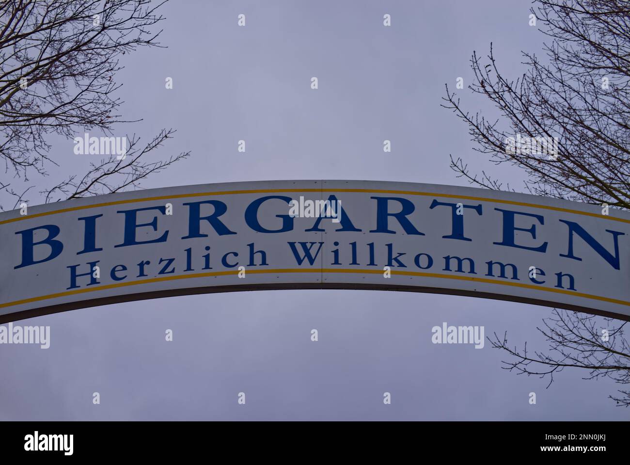 Big white entrance signboard with lettering "Biergarten, Herzlich ...