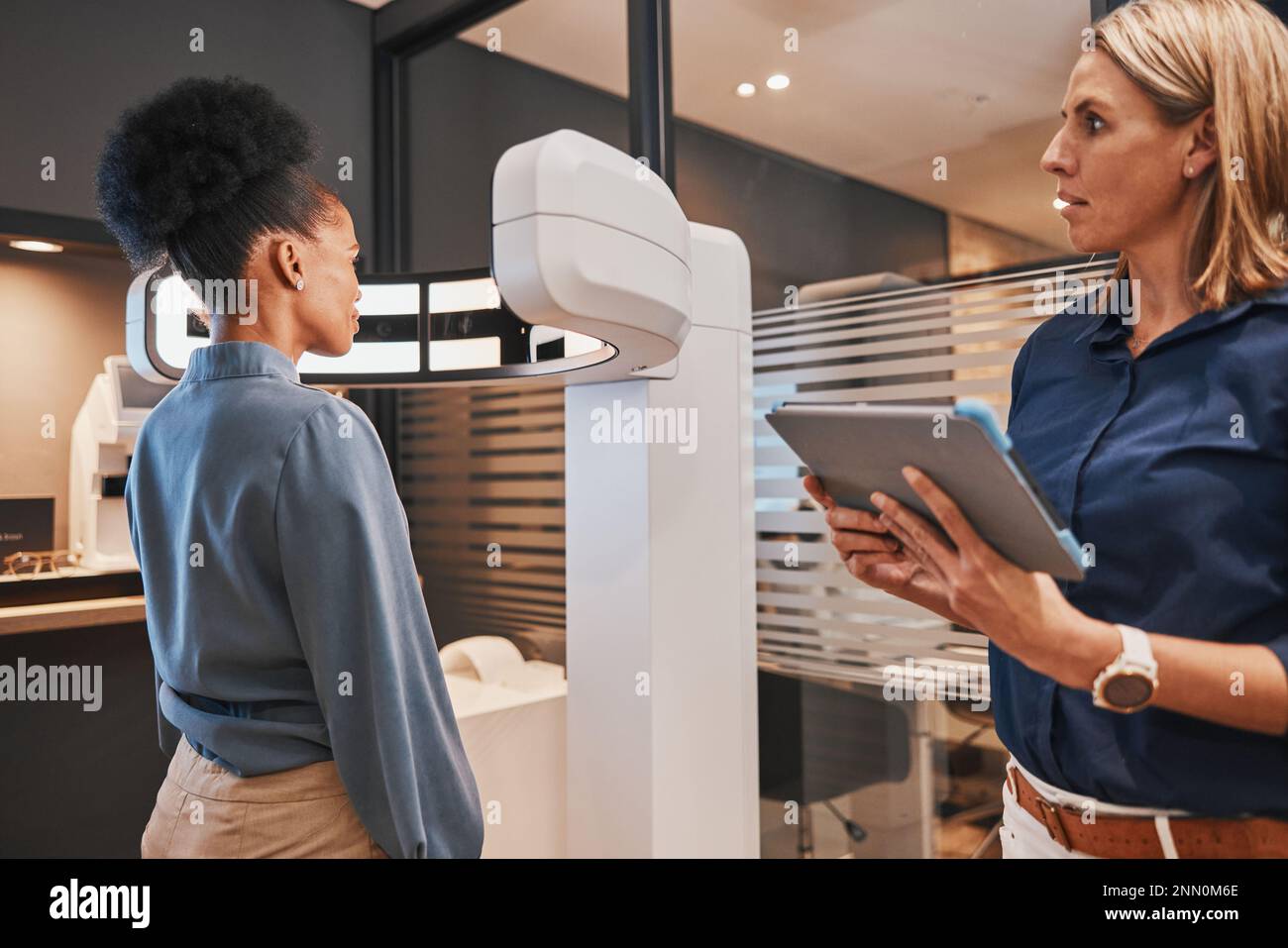 Eye exam machine, black woman and optometrist with tablet for vision ...
