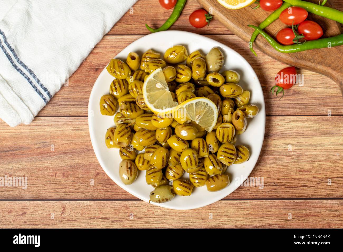 Grilled olives. Special green olives on a wood background ...