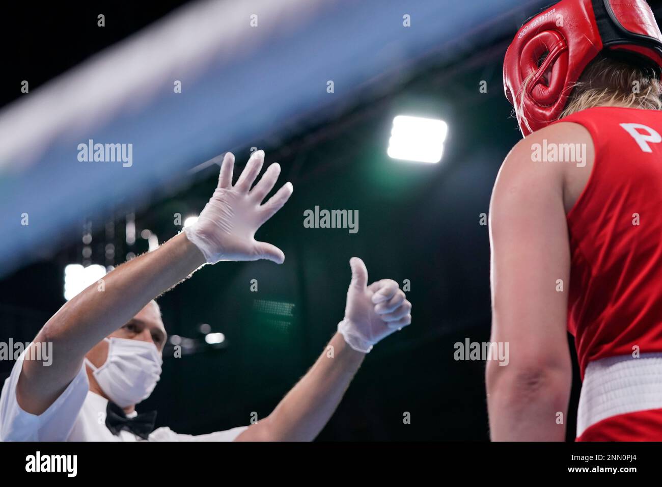 The referee counts during the women's middleweight 75-kg boxing match ...