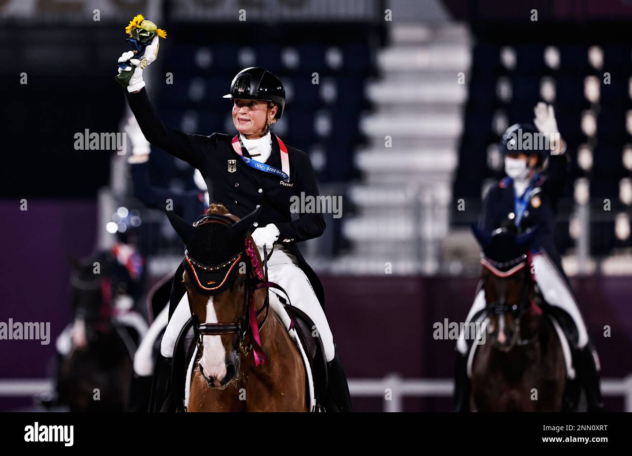 Gold medalist Isabell Werth of Germany rides on her horse together with ...