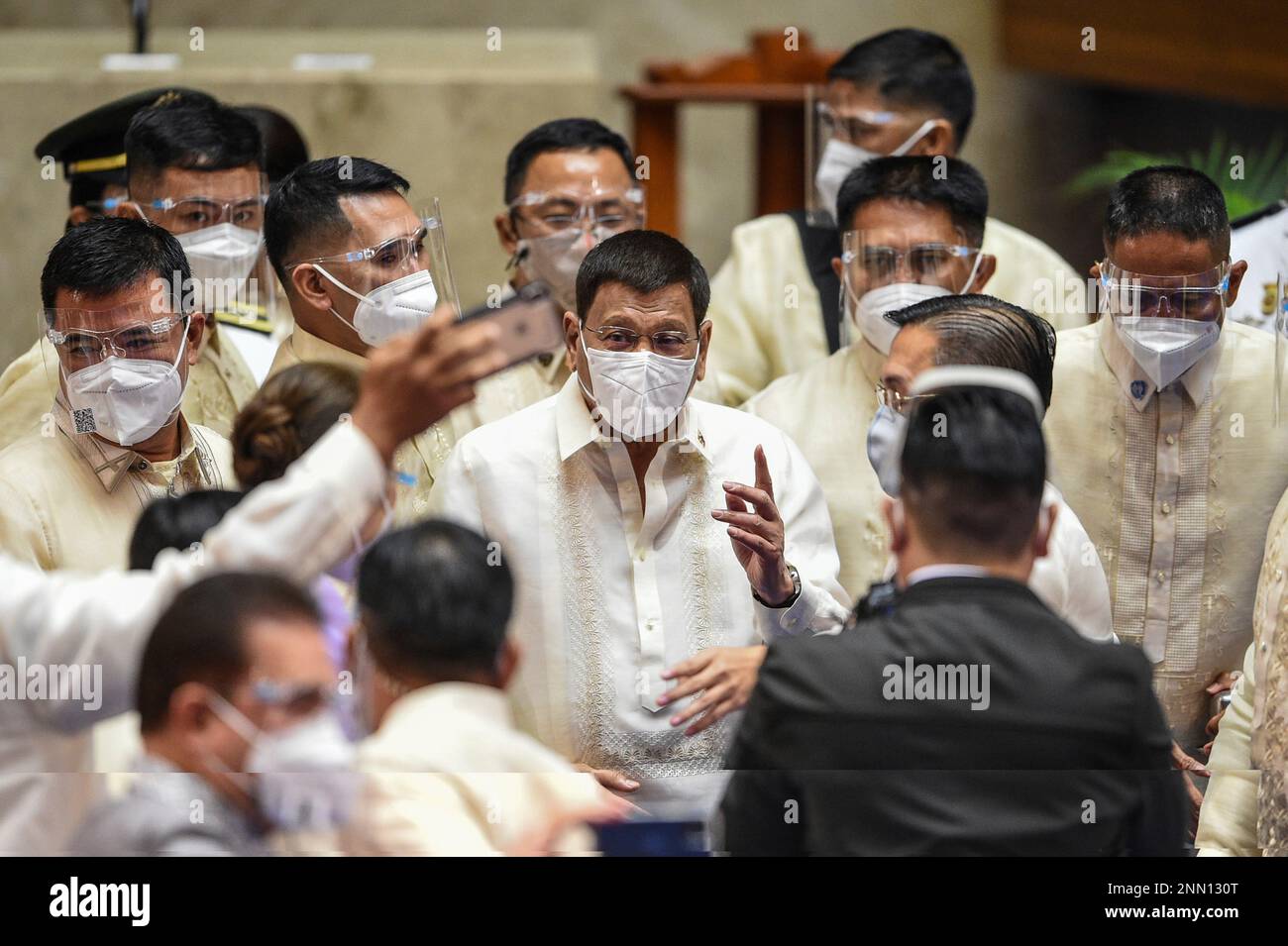 Philippine President Rodrigo Duterte is surrounded by security after he ...
