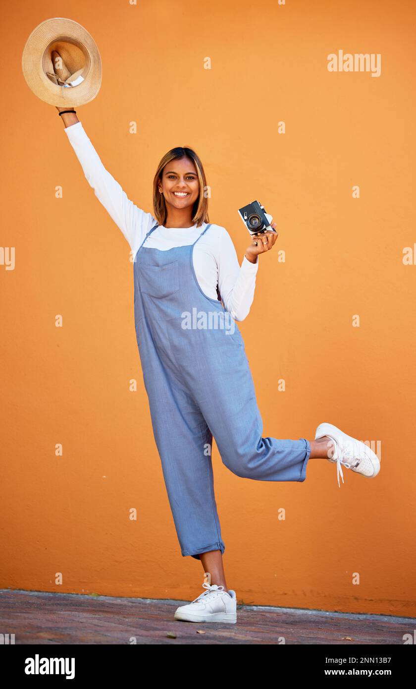 Camera, portrait and photographer black woman isolated on orange wall ...