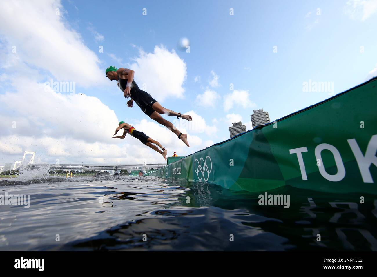 Athletes jump in to compete in the swim leg of the men's individual ...
