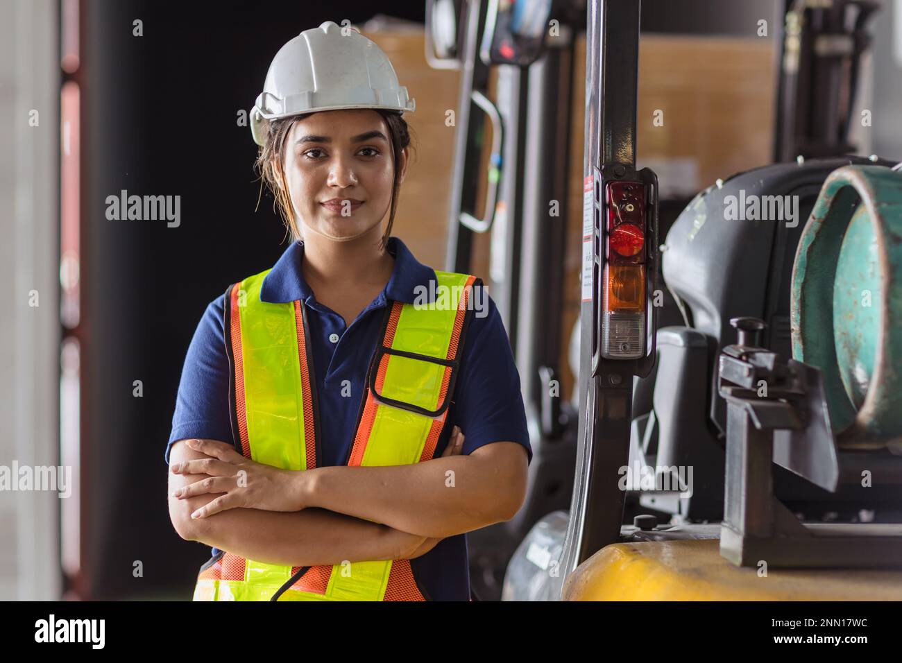 Indian woman staff worker engineer supervisor in safety suit work in factory warehouse Stock ...