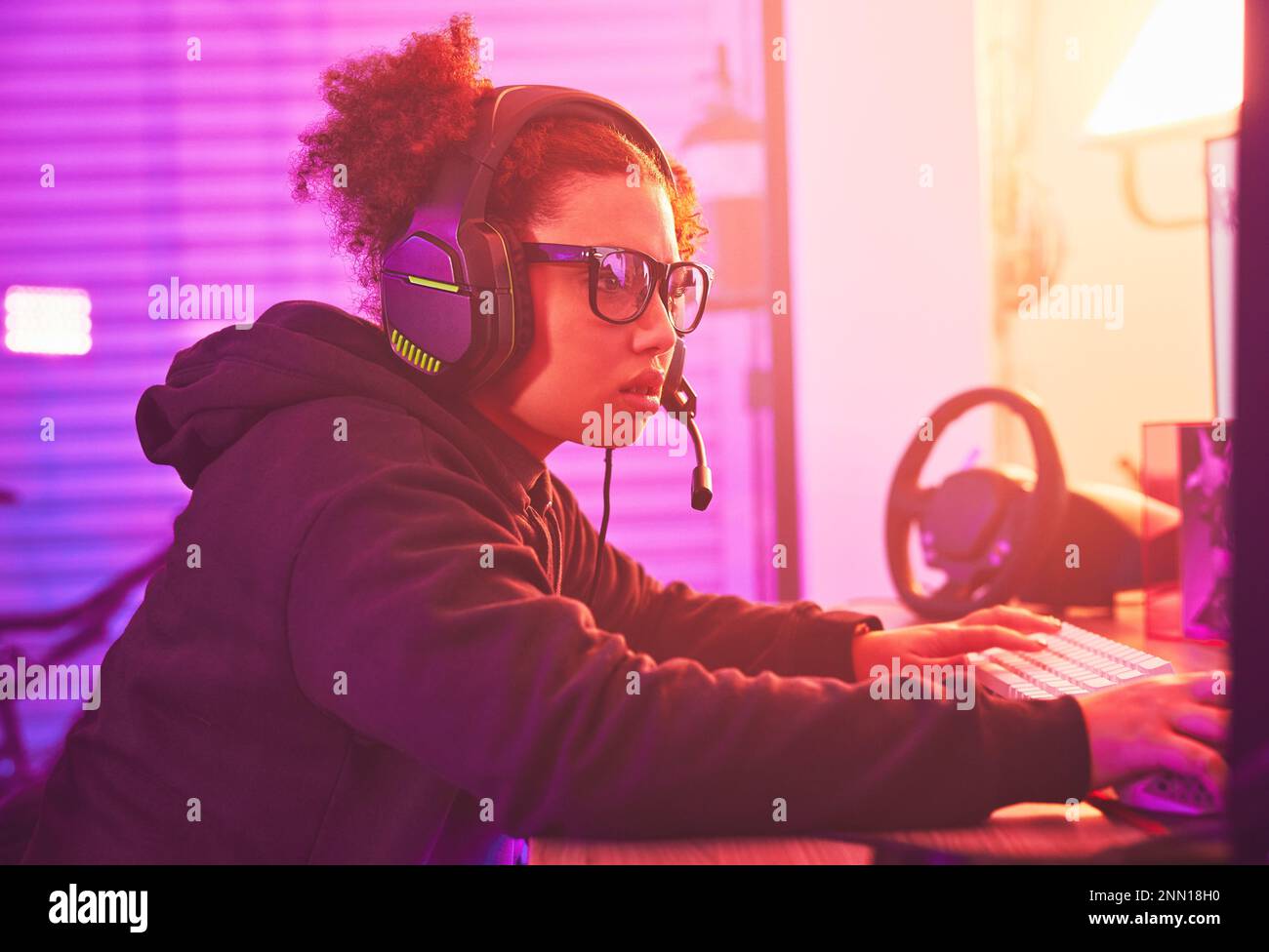 Computer games, young girl and headset in home for esports, online rpg ...