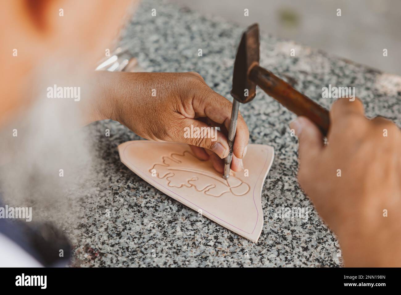 closeup hand working process leather handcraft in the leather workshop ...