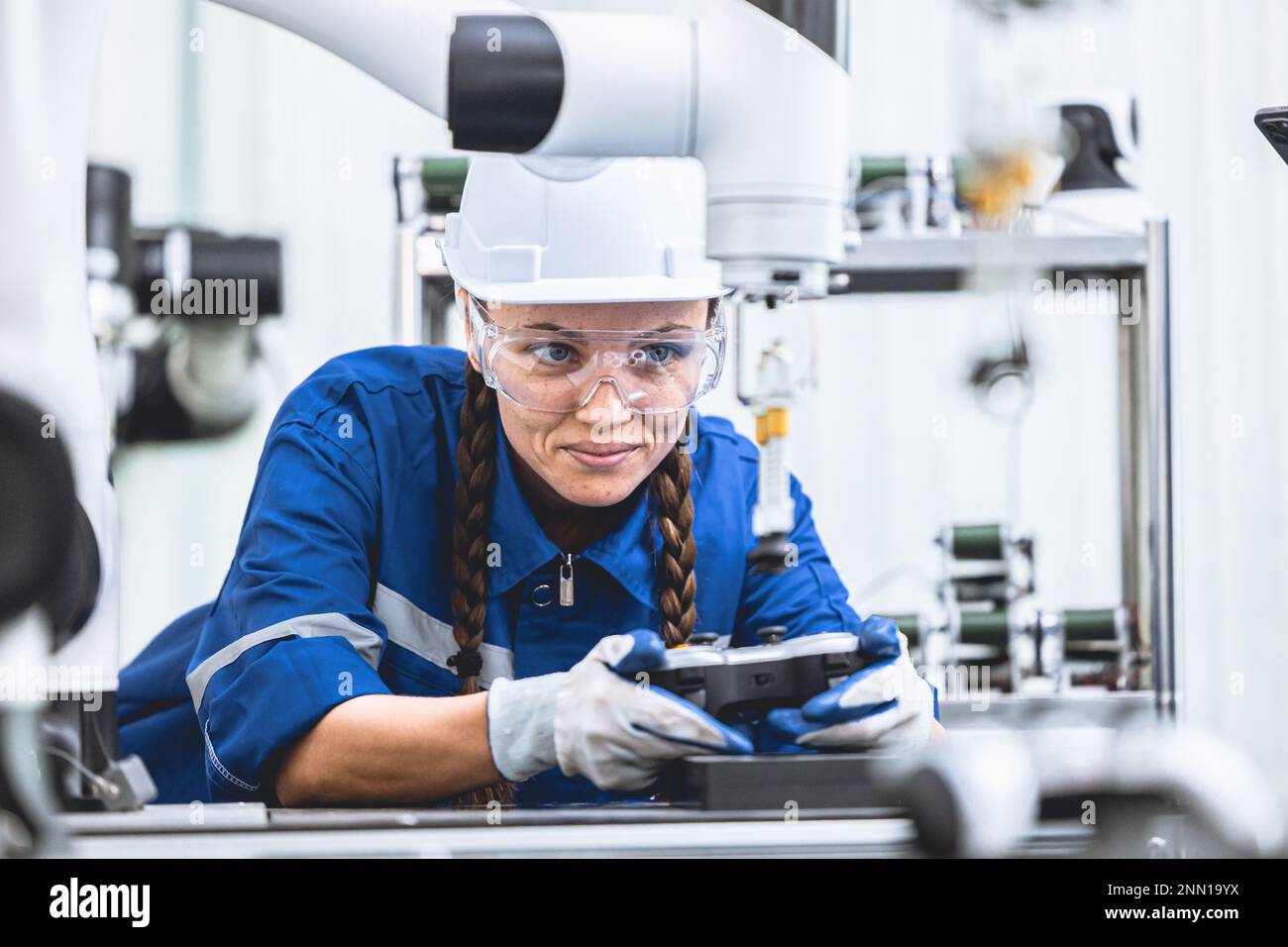 engineer woman worker working with robotic arm in productions lab ... engineer woman worker working with robotic arm in productions lab ...