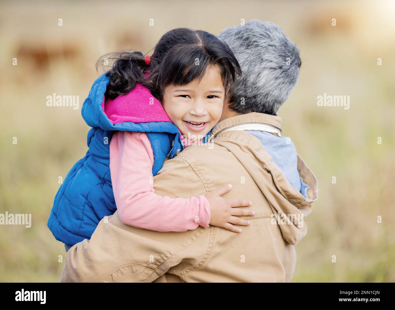 Hug, happy and portrait of a child with grandmother on a farm for ...