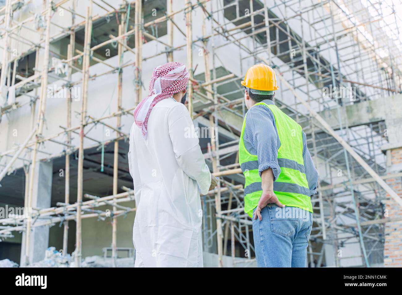 engineer standing with arub property investor looking under ...