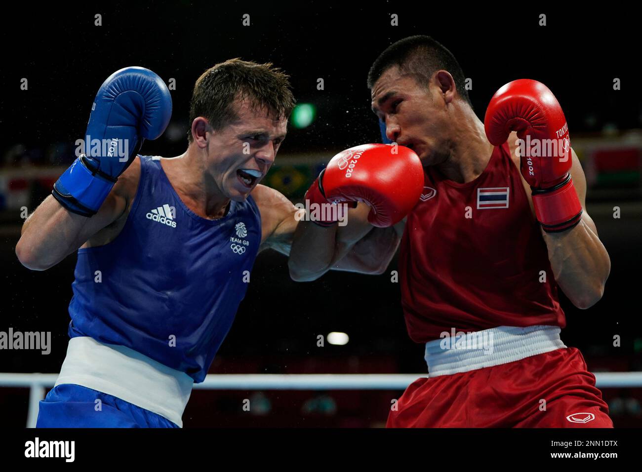 Thailand's Chatchai-Decha Butdee, right, exchanges punches with Britain ...