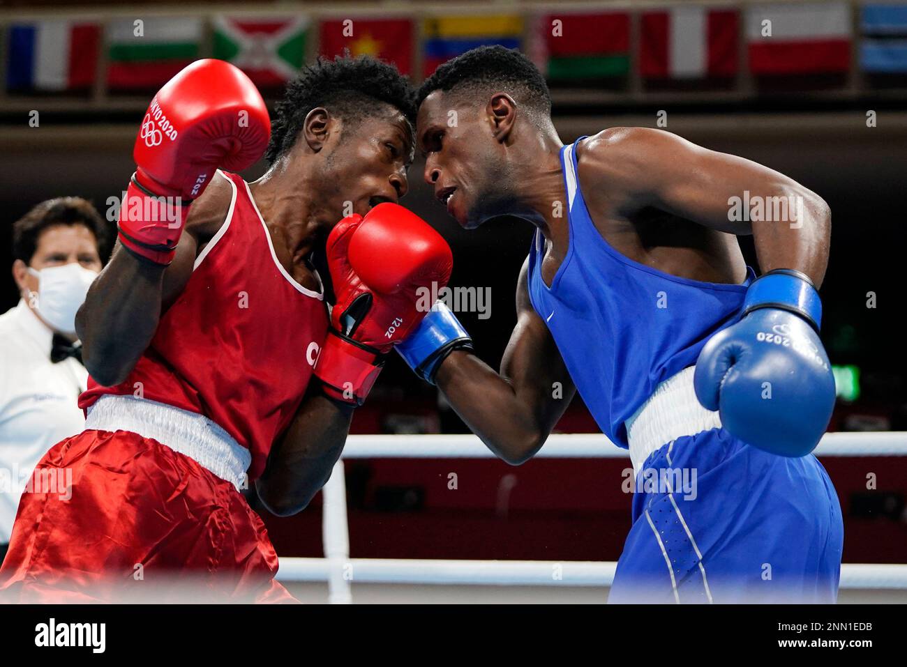 Cameroon's Albert Mengue Ayissi, left, exchanges punches with Switzerland's Thabiso Dlamini ...