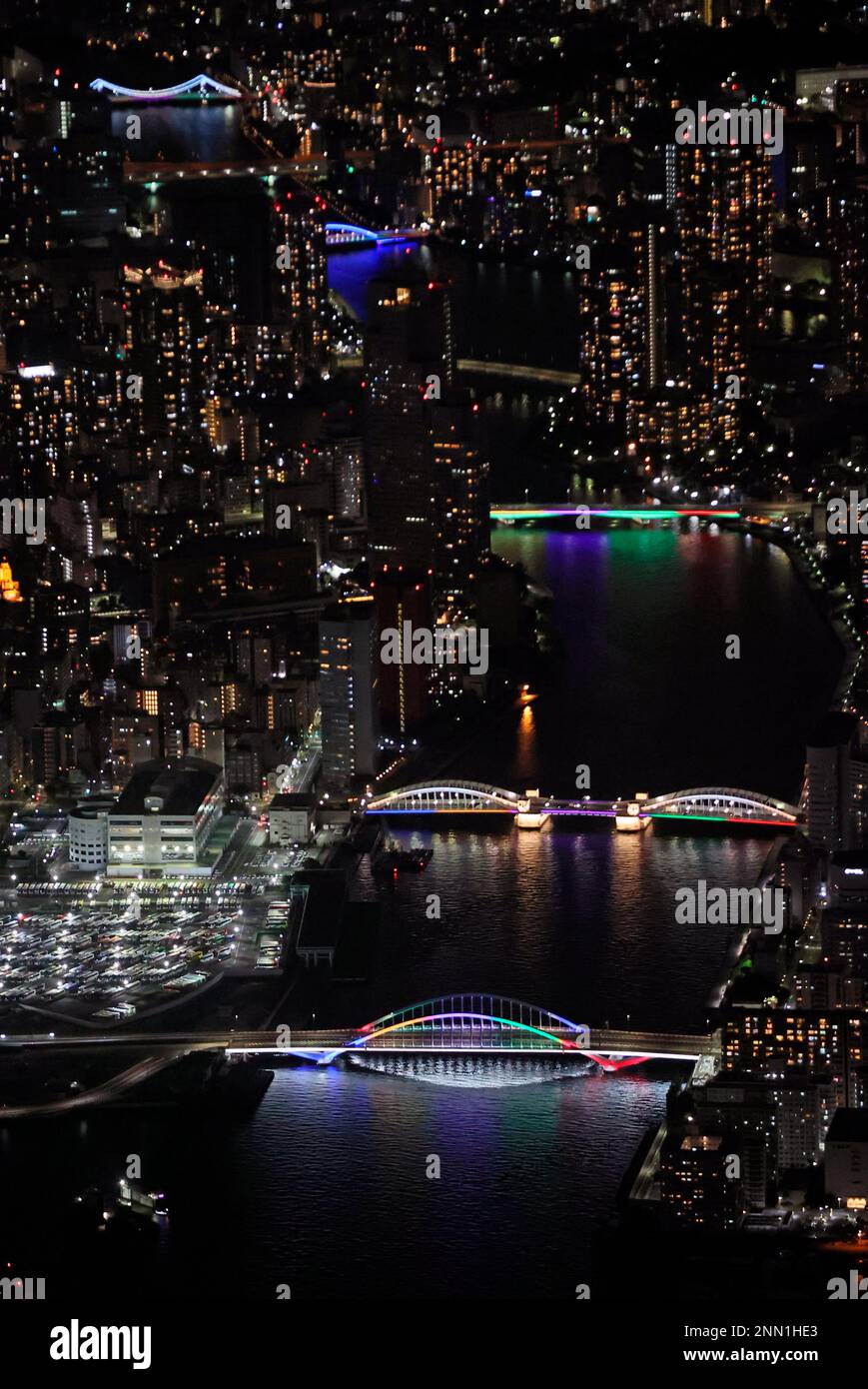 An aerial photo shows a bridge illuminated in Olympic colours in Tokyo ...