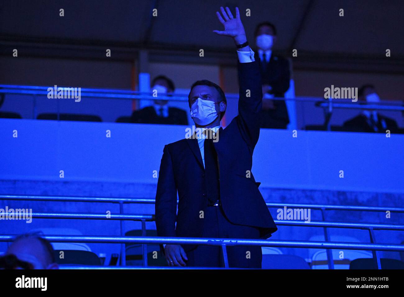 French President Emmanuel Macron waves during the opening ceremony in ...