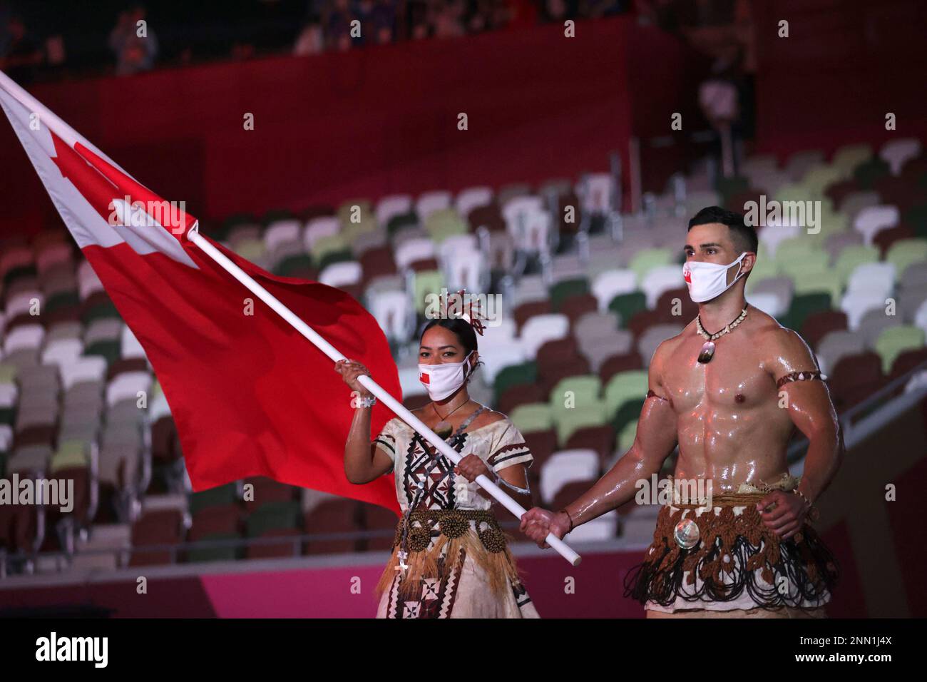 Malia Paseka and Pita Taufatofua, of Tonga, carry their country's flag ...