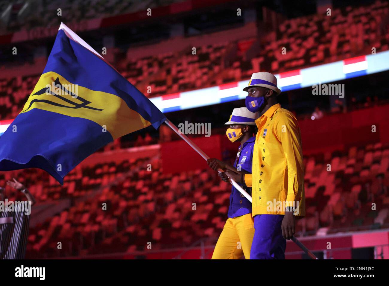 Danielle Titus and Alex Sobers, of Barbados, carry their country's flag ...