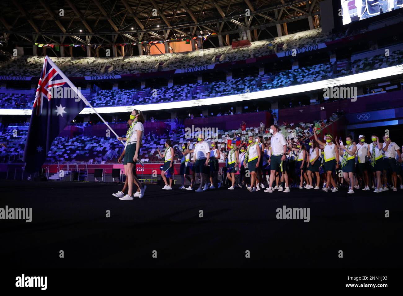 Cate Campbell and Patty Mills, of Australia, carry their country's flag ...