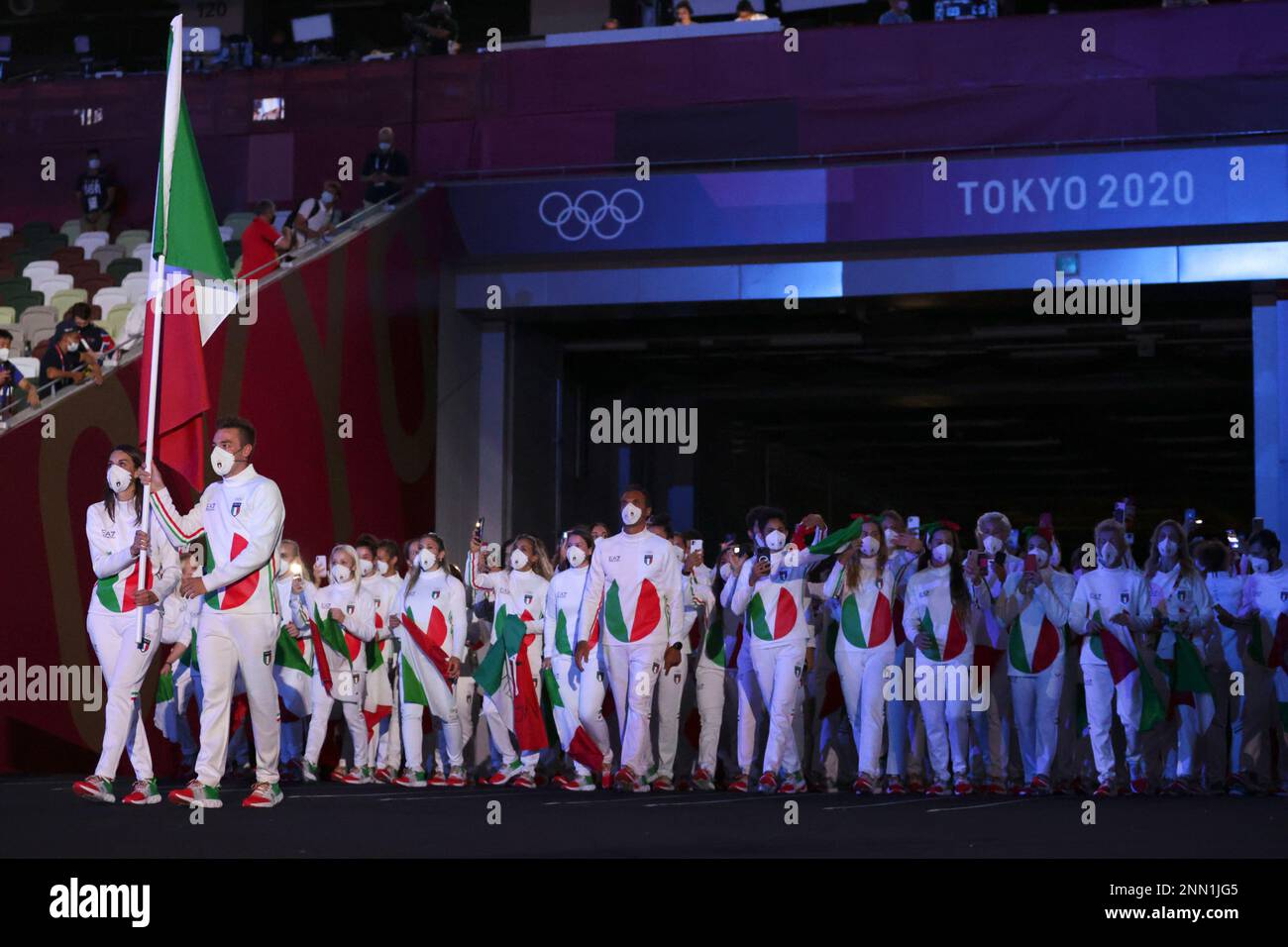 Jessica Rossi and Elia Viviani, of Italy, carry their country's flag ...