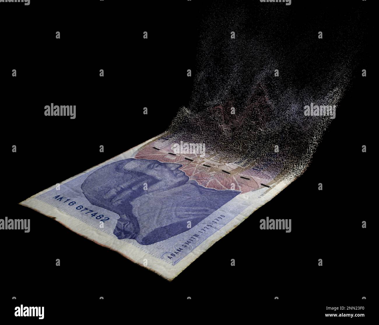 A concept image showing a half dissolved flat paper UK pound bank note ...