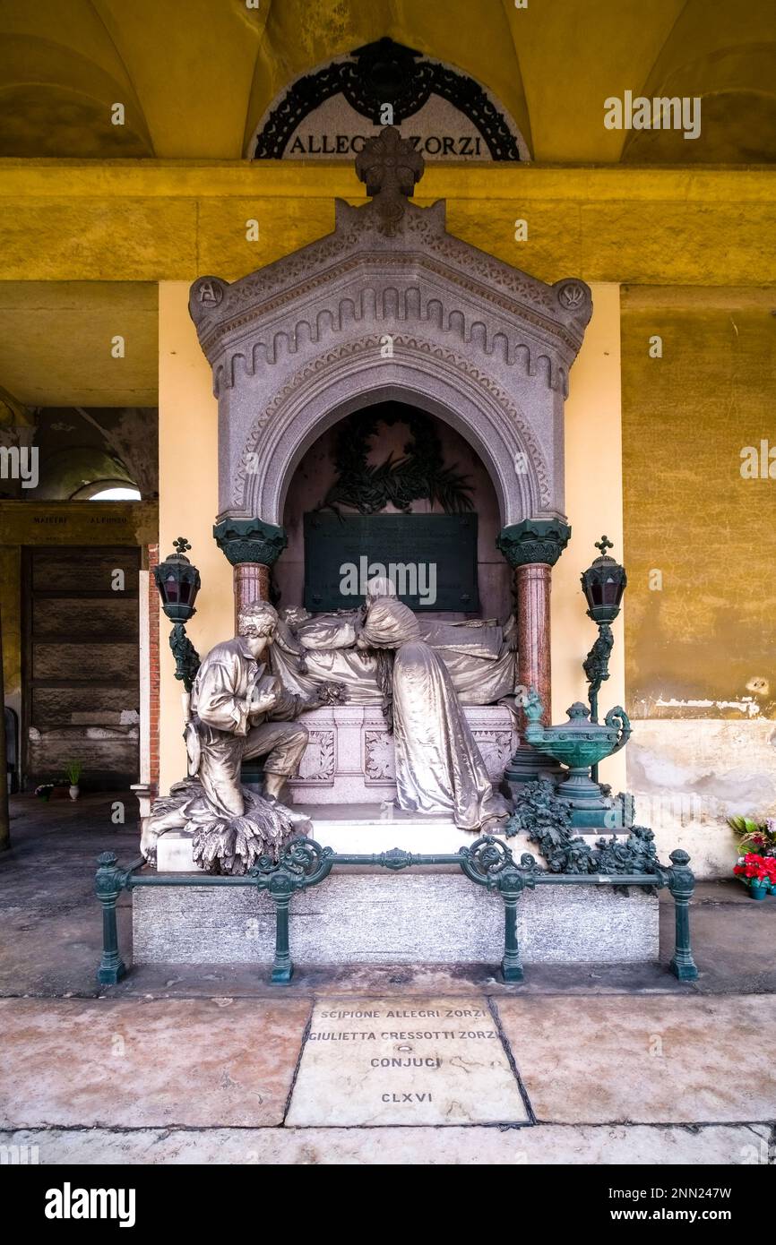 Artfully designed tomb with statues of mourning people at the Cimitero ...