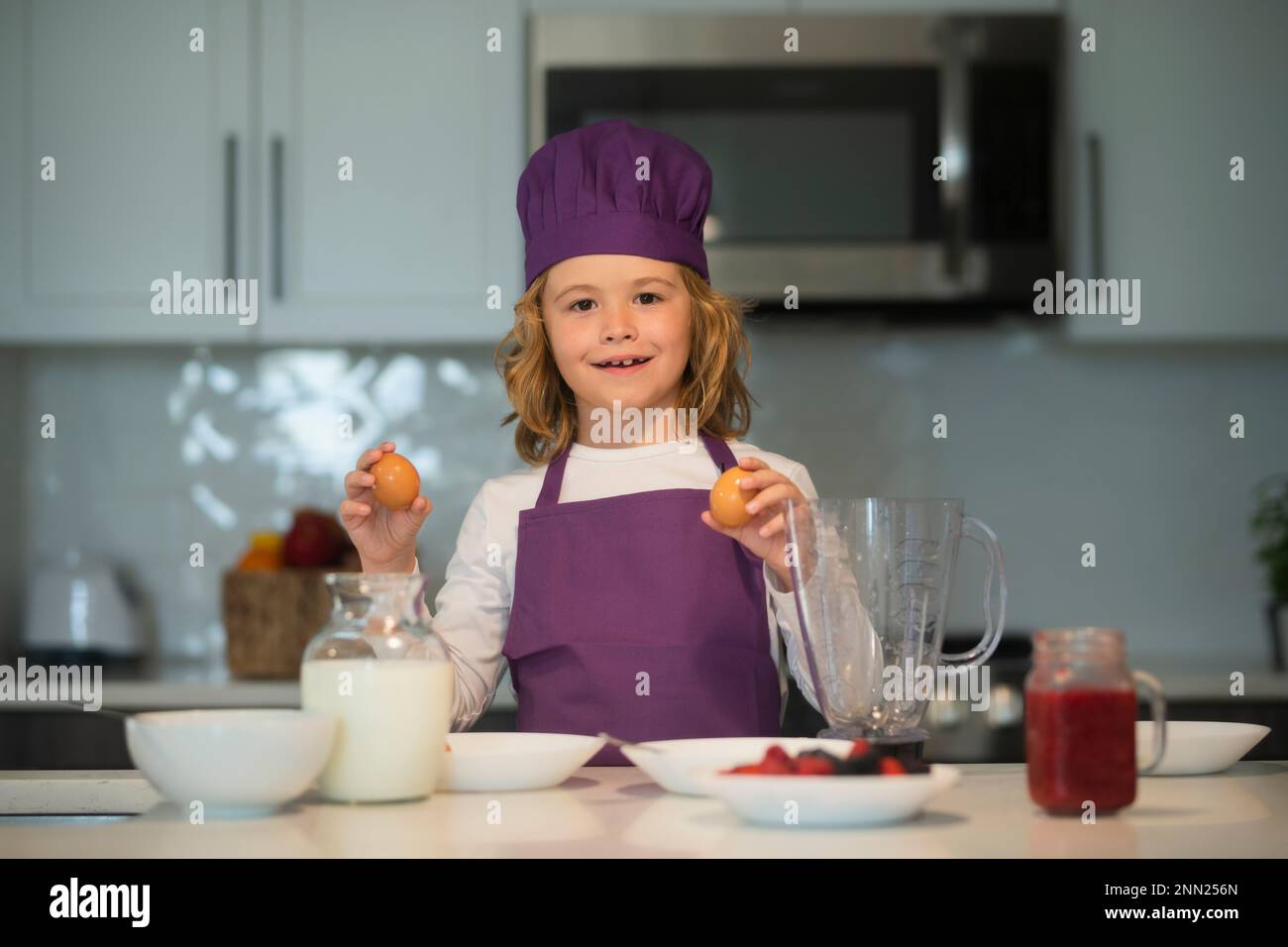 Child wearing cooker uniform preparing healthy food. Healthy ...