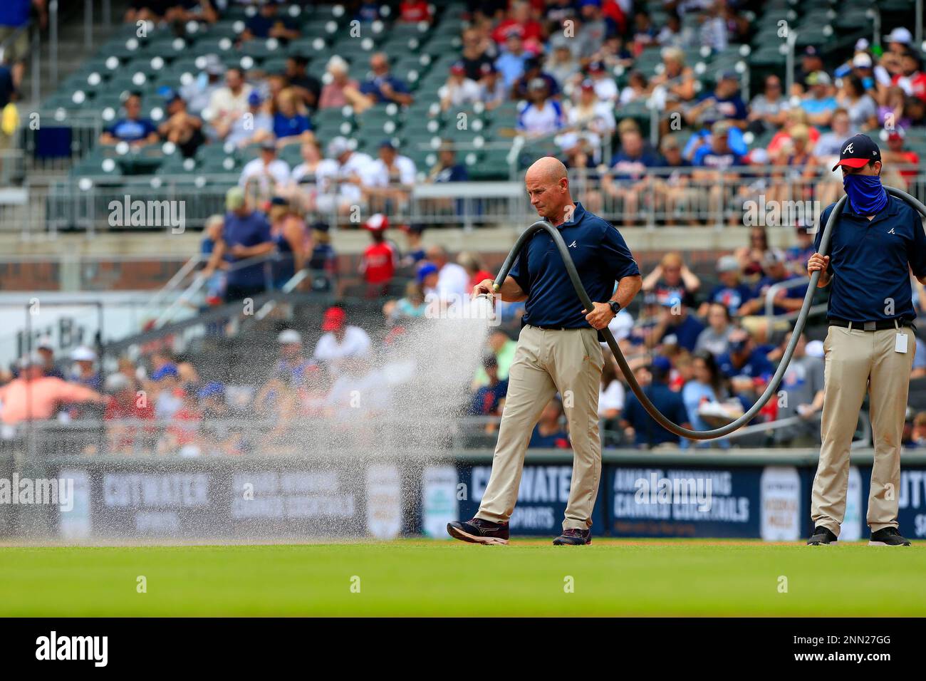 ATLANTA, GA - JULY 18: The Truist Park grounds crew preps the field ...