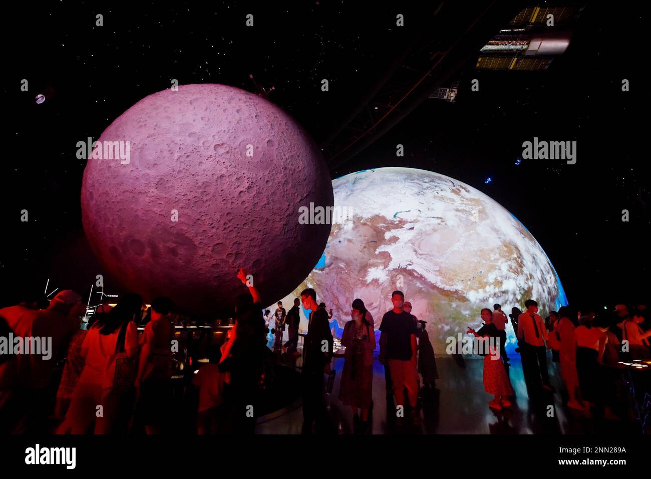 Visitors pass by a model of the Moon at Shanghai Astrology Museum in ...