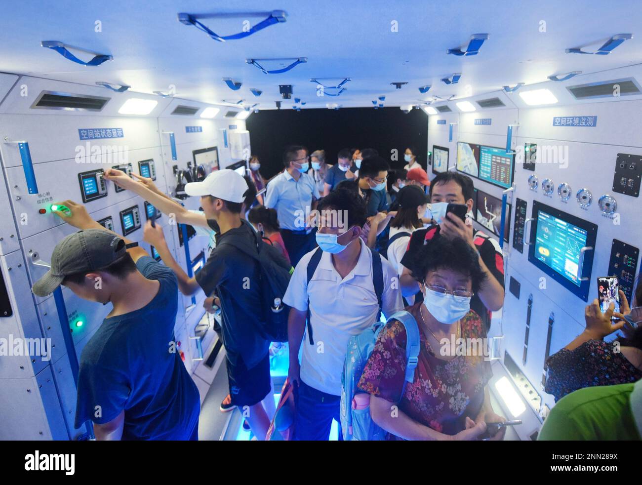 Visitors walk through the lifesize model of Tianhe core module of the ...