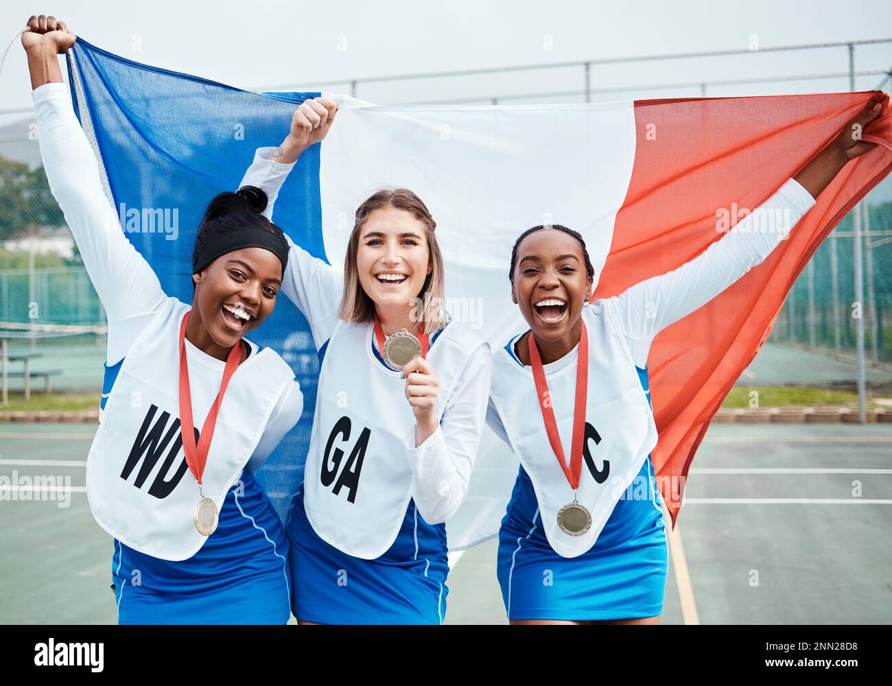Netball winning portrait, flag and sports team celebration, excited or ...