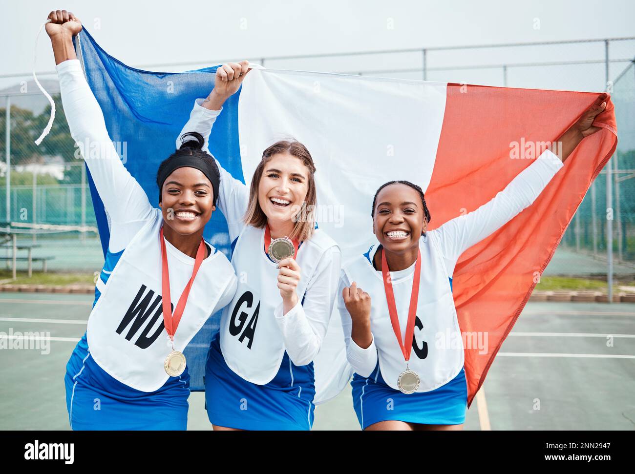 Netball win, flag portrait and sports team celebration, excited or ...