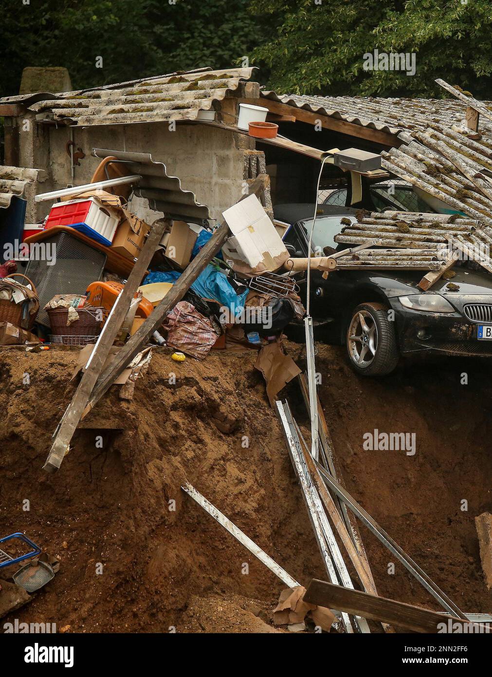 Debris of collapsed houses is pictures in the Blessem district of ...