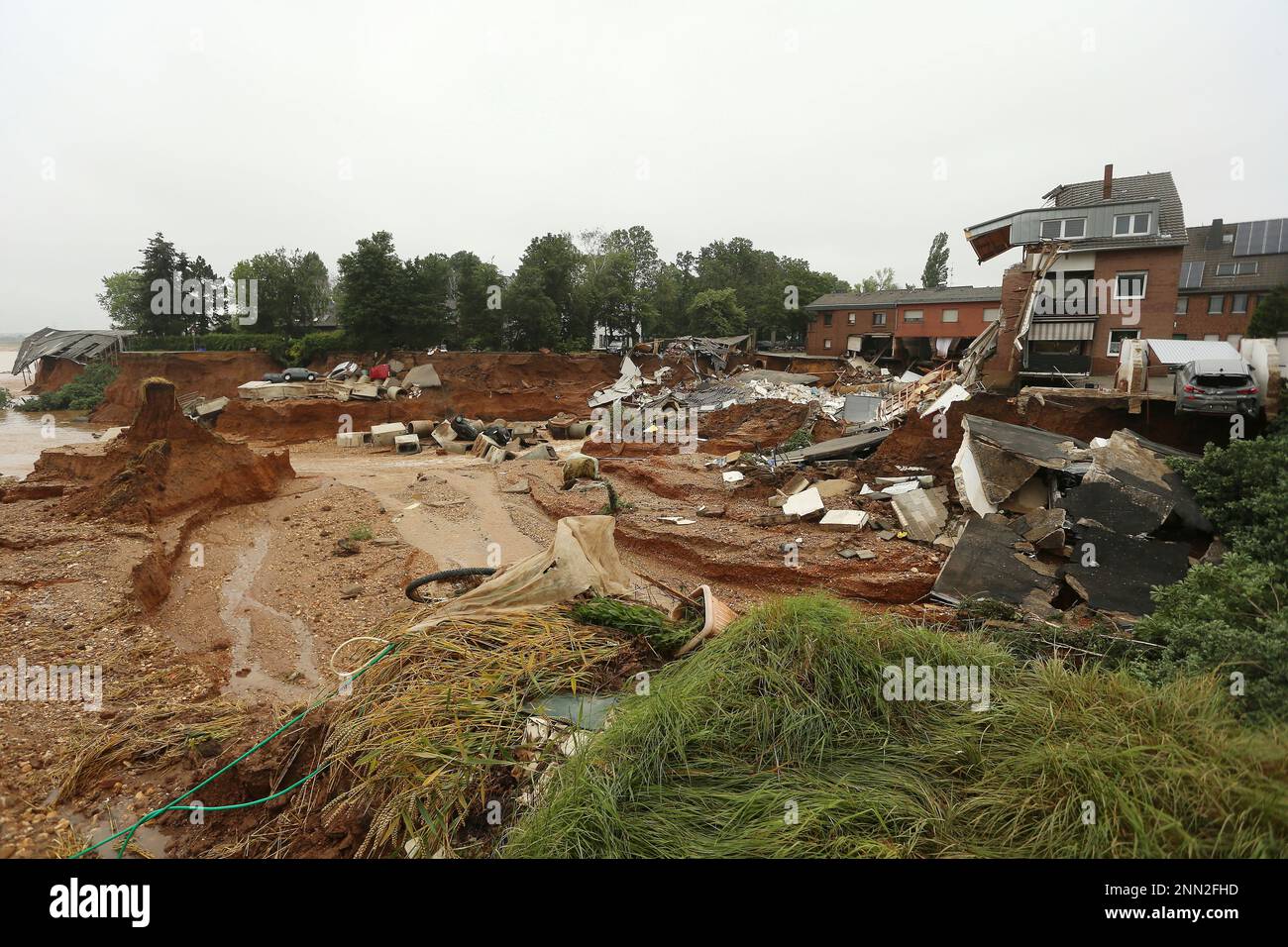 Debris of collapsed houses is pictures in the Blessem district of ...