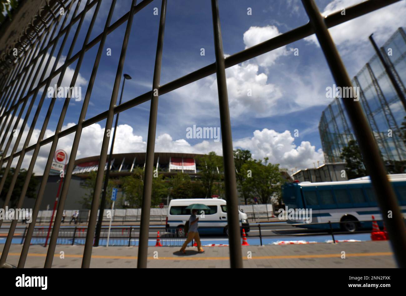 Security guards look out around the National Stadium in Shinjuku Ward ...