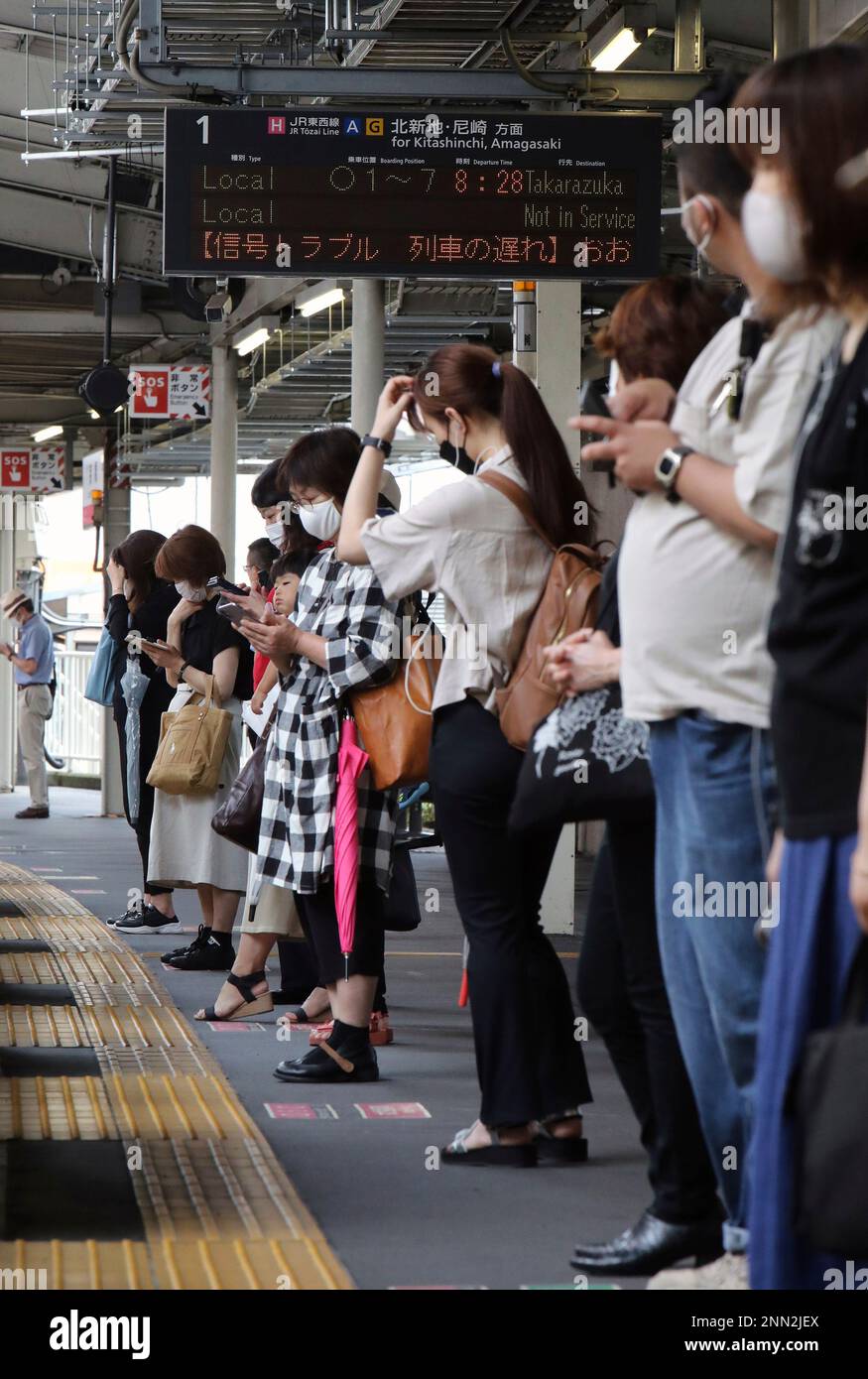 The platform of West Japan Railway Company is crowded with many ...