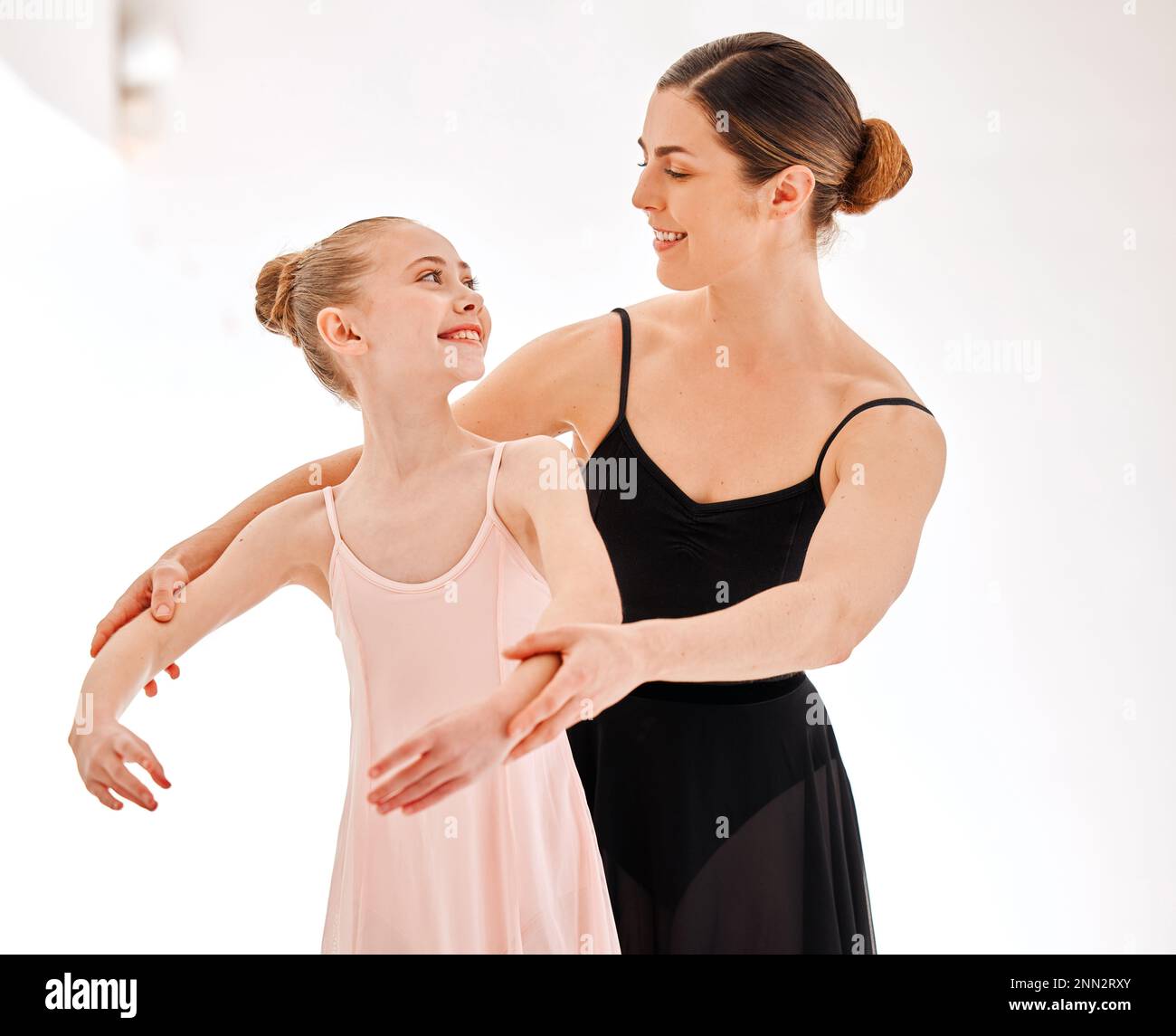 Ballet, learning class and dance teacher with child student in studio ...