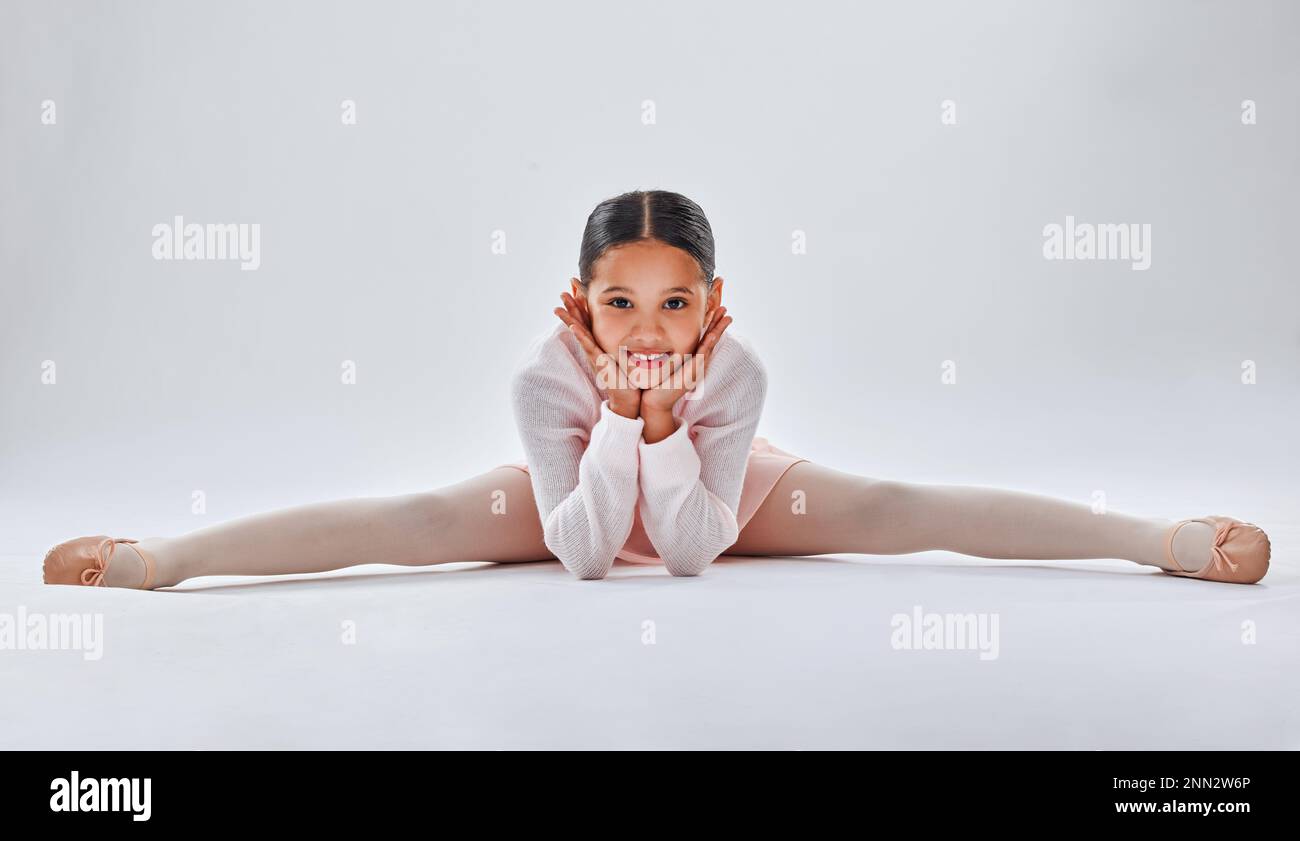 Ballet, dancer and young girl doing the split, smile in portrait with ...