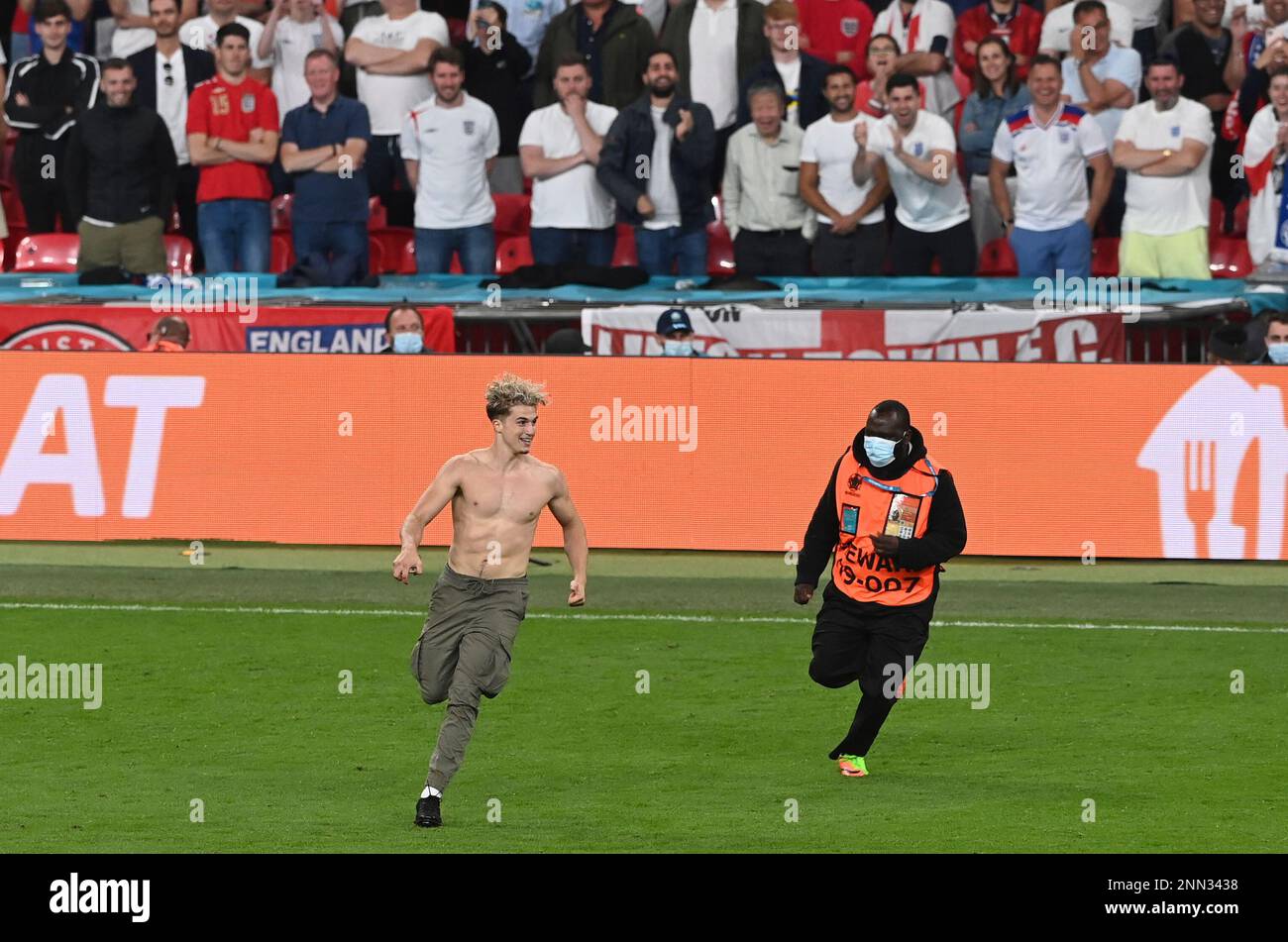 A pitch invader runs onto the field during the Euro 2020 final soccer ...